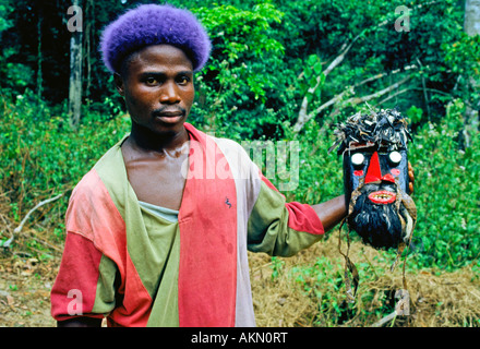 A man holds a traditional animist tribal mask Stock Photo - Alamy