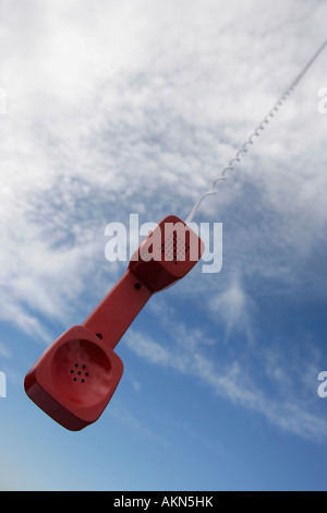 A telephone receiver dangling from the sky Stock Photo - Alamy