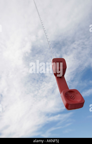 A telephone receiver dangling from the sky Stock Photo - Alamy