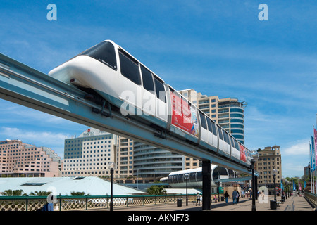 Sydney Monorail crossing over bridge on elevated track with pedestrians ...