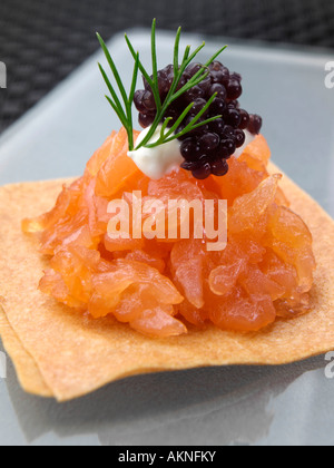 Close-up of salmon roe canapes on square glass plate Stock Photo - Alamy
