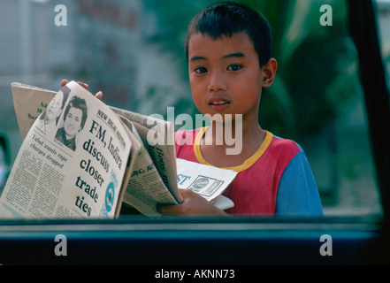 Child labor in the Philippines, boy selling fruits and vegetables on a ...