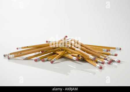 Close up of stack of yellow pencils with erasers and copy space on blue ...