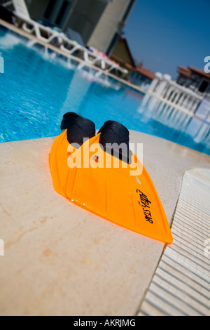 Flippers lying on the side of a swimming pool Stock Photo - Alamy