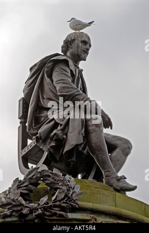 Statue of William Shakespeare sitting on top of the Gower Memorial with ...