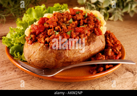BAKED POTATO WITH BOLOGNESE SAUCE AND BASIL Stock Photo - Alamy