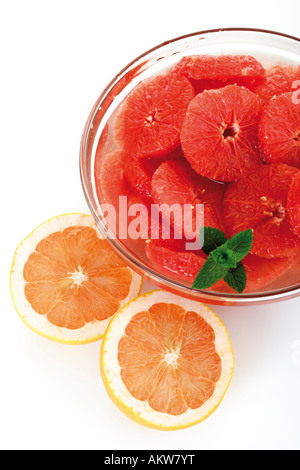 Cut grapefruit in white bowl Stock Photo - Alamy