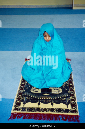Muslim child praying at Islamic school Stock Photo - Alamy