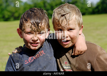 Two friends covered with mud Stock Photo - Alamy
