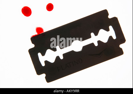 Photo of Razor blade with a drop of blood on white background Stock ...