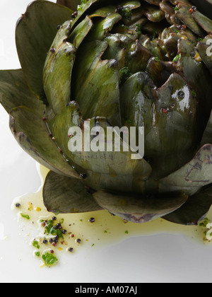 cooked whole artichoke on a white plate Stock Photo - Alamy
