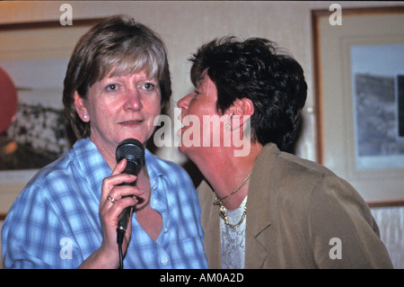 two middle aged women karaoke singers Stock Photo - Alamy