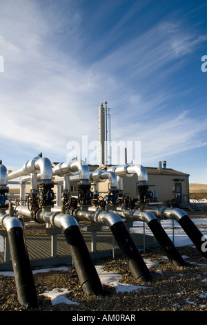 Gas pipeline riser with compressor and dehy station in the background ...