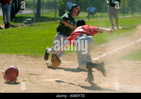 A Baseball Player Is Sliding Into Home Plate To Beat the Throw Home And ...