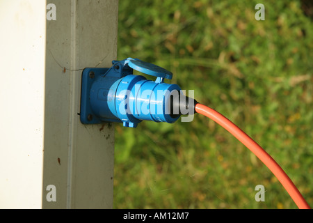 Caravan electrical hook-up cable with mains power adapter plugged Stock ...