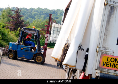 Loading an IBC onto a haulage lorry Stock Photo - Alamy