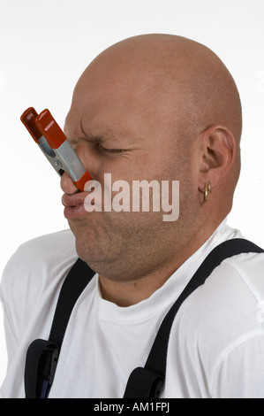 A man with a clamp on his nose Stock Photo - Alamy