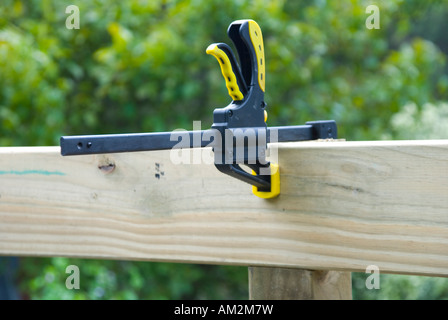 Clamped timber on a DIY garden project Stock Photo - Alamy
