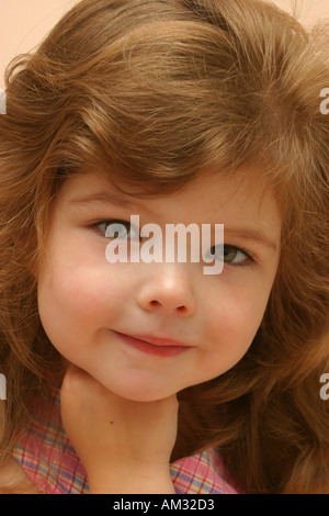 Girl with cheeky grin Stock Photo - Alamy