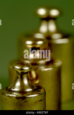Three french copper scale weights aligned Stock Photo - Alamy