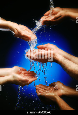 Hands pouring water from one to the other at sunset. Silhouette. Andhra ...