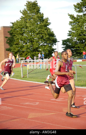 Teenage boy runners at a high school track and field district meet ...