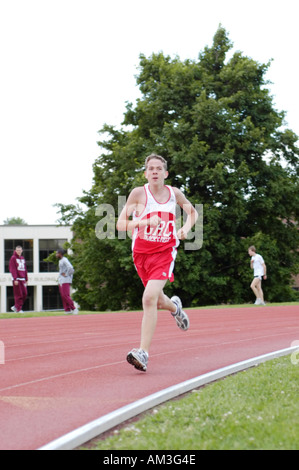 Teenage boy runner at the Track and Field competition during the ...
