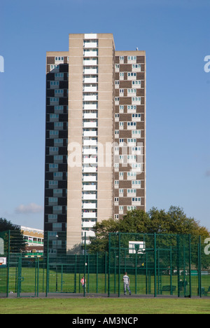 Council tower block of flats towering over rooftops with dark sky ...