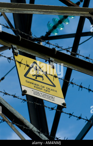Electricity pylon with warning notice (in German Stock Photo - Alamy