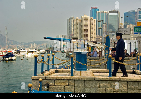Soldier at the Noonday Gun at the Victoria harbour in Hong Kong ...