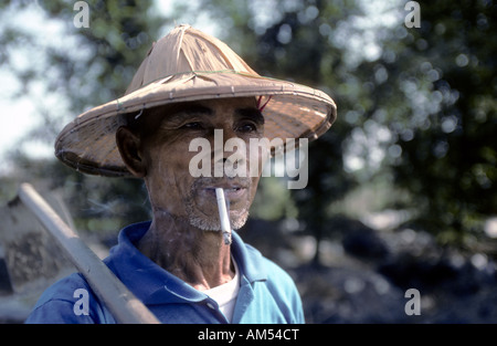 Farmer with hat smoking cigarette. Portrait of an old senior man ...