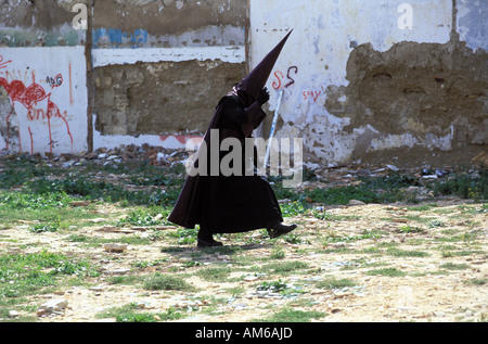 Penitent in traditional hood and robe in an Easter parade on Holy ...