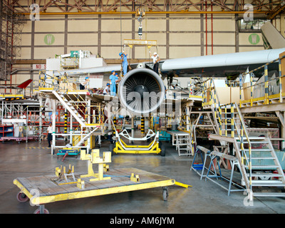 Workers in a maintenance aviation facility at the SIA Engineering ...