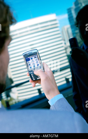 rear view of man hand using smart phone on office desk Stock Photo - Alamy