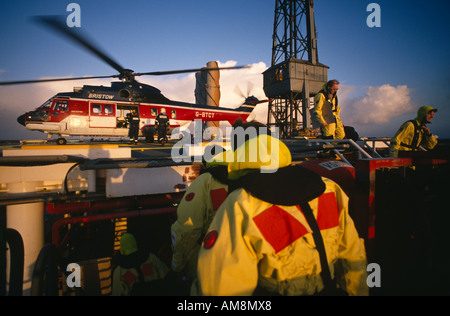 Offshore Oil Platform personnel crew change boarding helicopter on oil ...