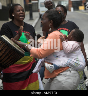 Women drumming,singing and dancing Zimbabwe anti Mugabe democracy vigil ...