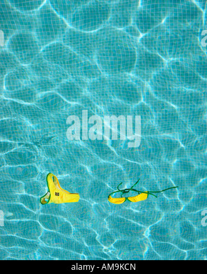 Woman floating on lilo in tropical lagoon with man above watching Stock ...