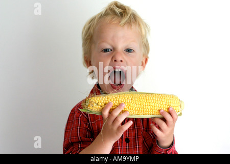 Boy eating sweet corn Stock Photo - Alamy