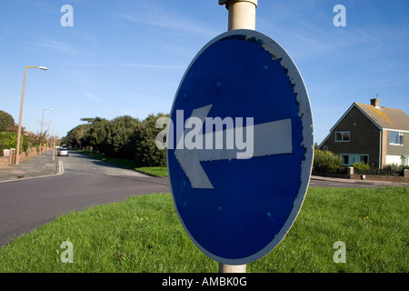 British keep left symbol on bollard in middle of road Stock Photo - Alamy