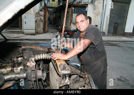 Cuban car mechanic repairing 1950s vintage American Chrysler pickup ...