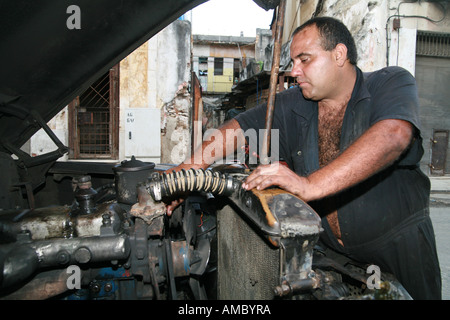 Cuban car mechanic repairing 1950s vintage American car / Yank tank ...