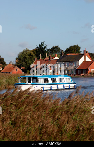 The Norfolk Broads A pleasure cruiser passes The Ferry Inn at Stokesby ...