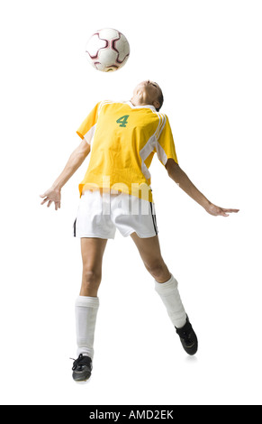 Teenage girl heading soccer ball Stock Photo - Alamy