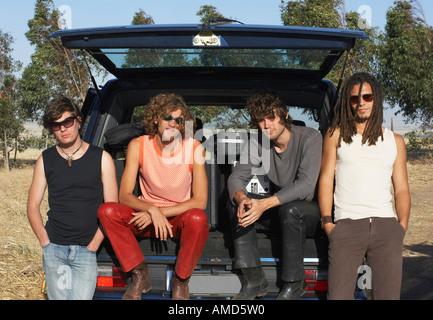 A four man band posing Stock Photo - Alamy