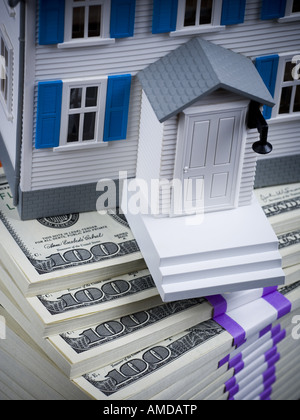 A high angle closeup shot of houses on a grass field with a mountain ...