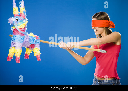 Woman with blindfold hitting pinata with stick Stock Photo: 28696371 ...