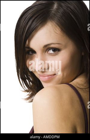 flirty woman smiling and looking at camera on red Stock Photo - Alamy