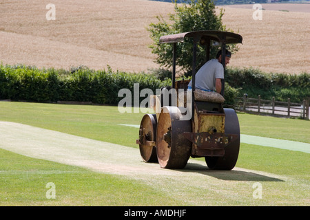 Mechanical roller irons out any bumps on the cricket pitch and wicket ...