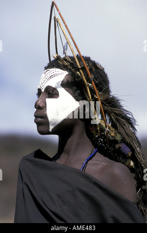 Young Maasai man after circumcision wearing black Shuka white face ...