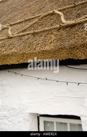 detail of rope work on a thatched roof on a cottage in Llanon village ...